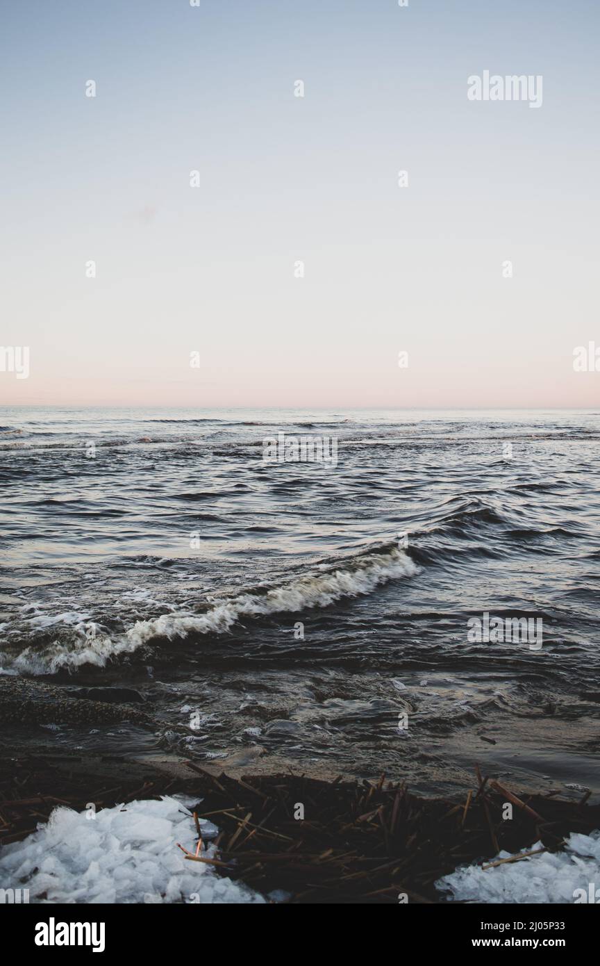 Sea at sunset. View from pier. Waves washing over the embankment of ...
