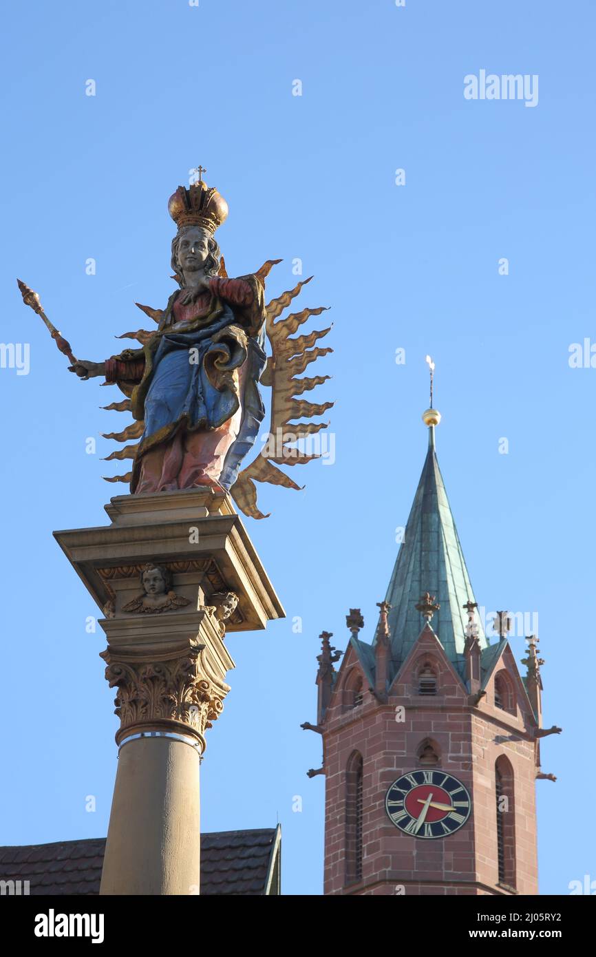 Madonna figure with spire of St. Gallus church on market square in ...