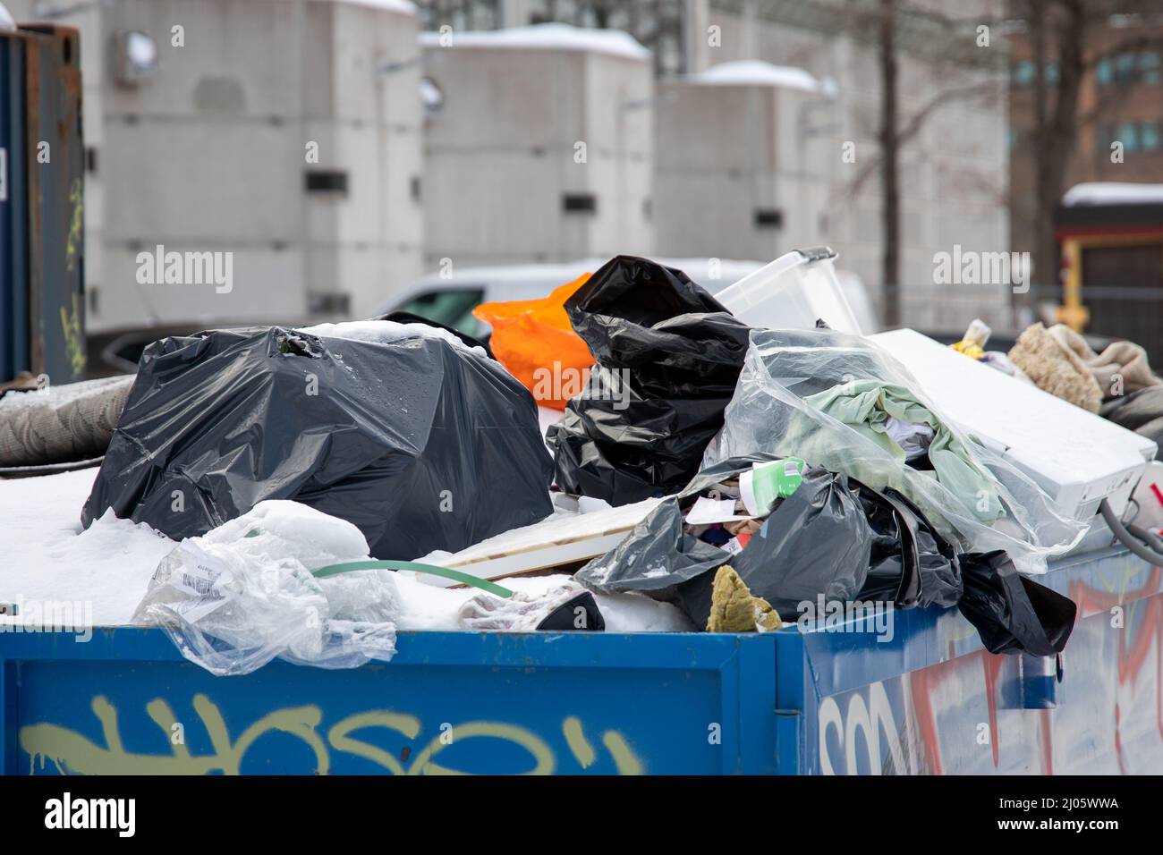 Closeup shot of a dumpster full of garbage and trash on a daytime Stock ...