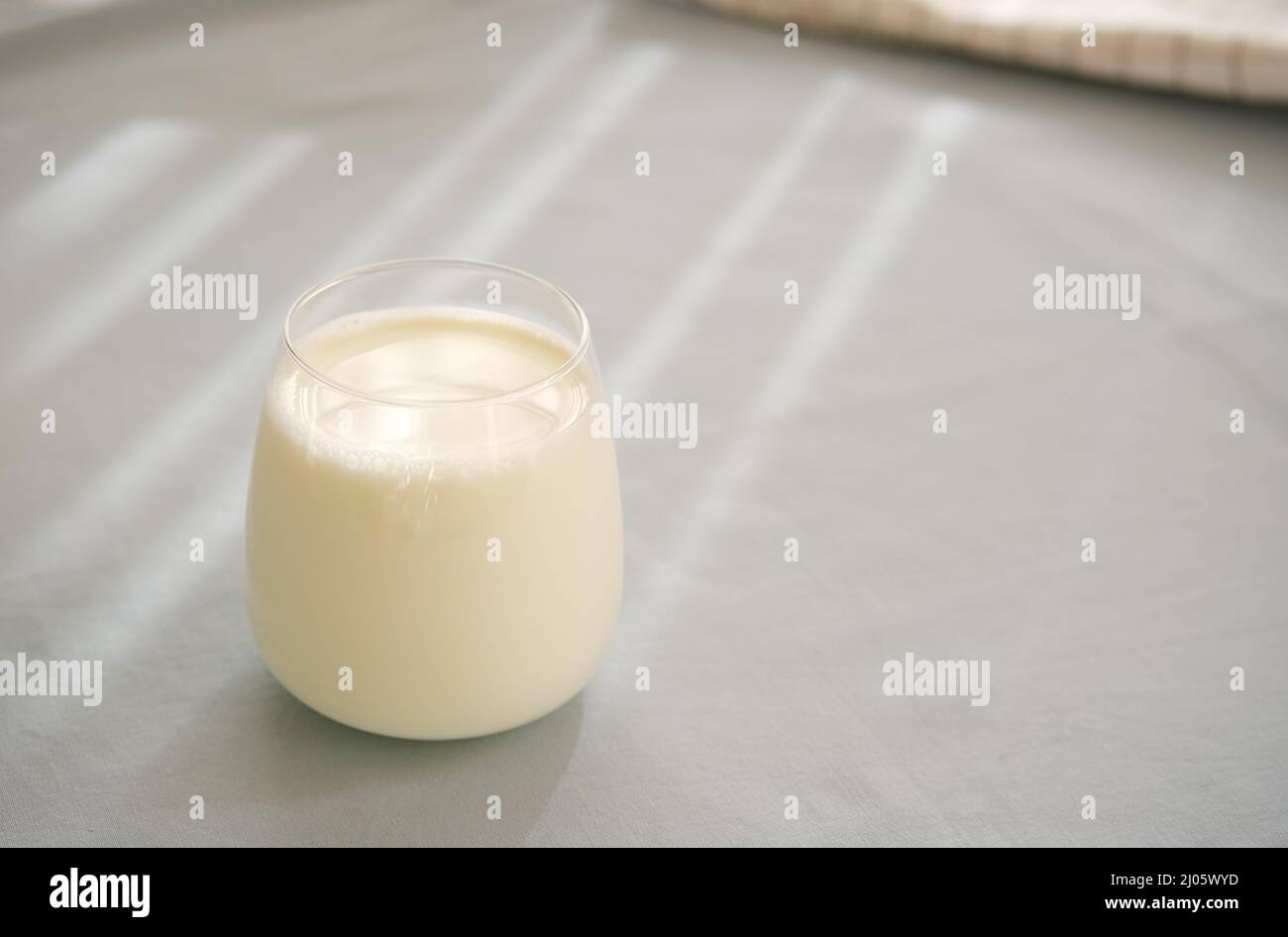 Glass of milk on the table with blue background Stock Photo - Alamy