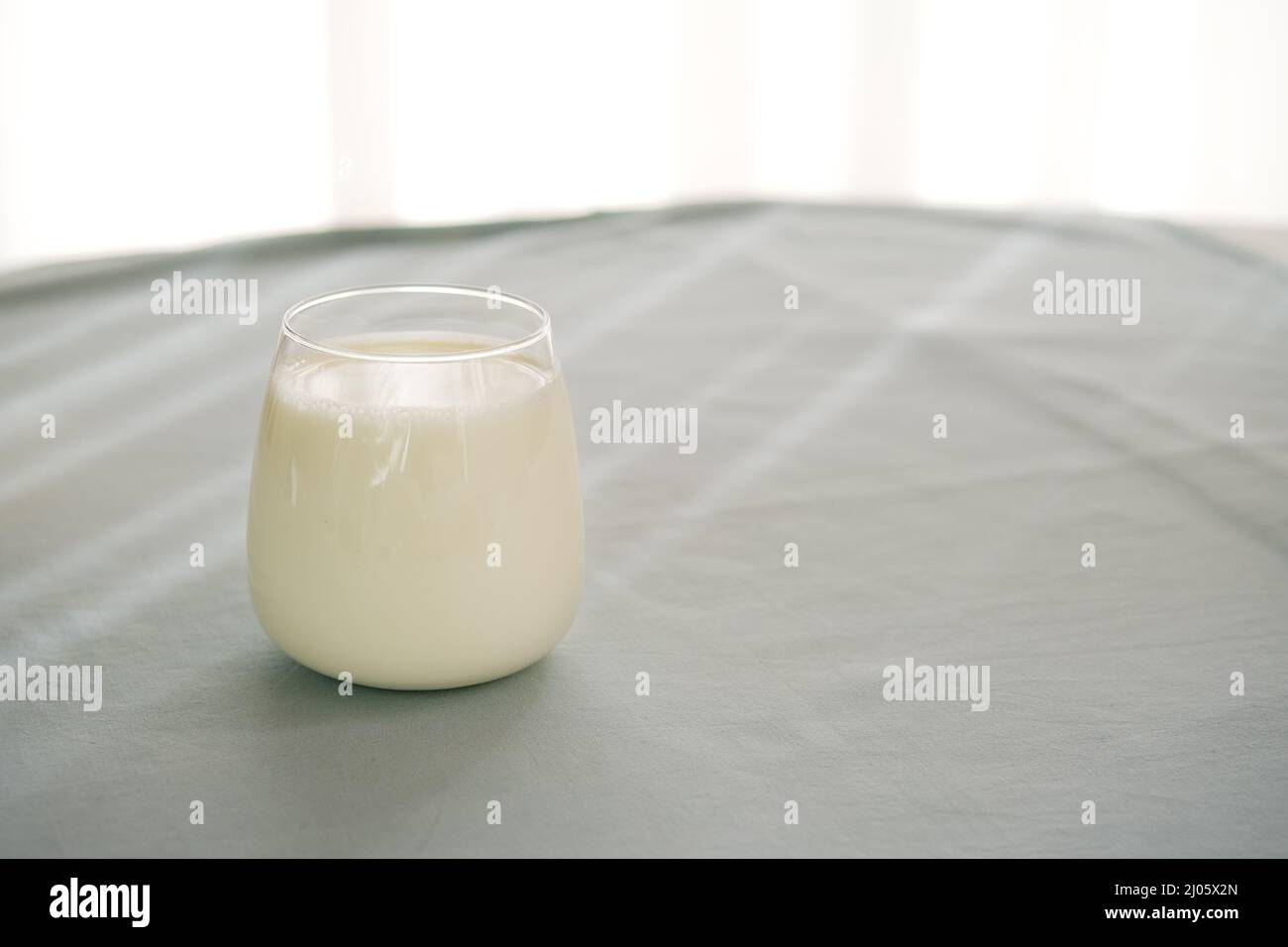 Glass of milk on the table with blue background Stock Photo - Alamy