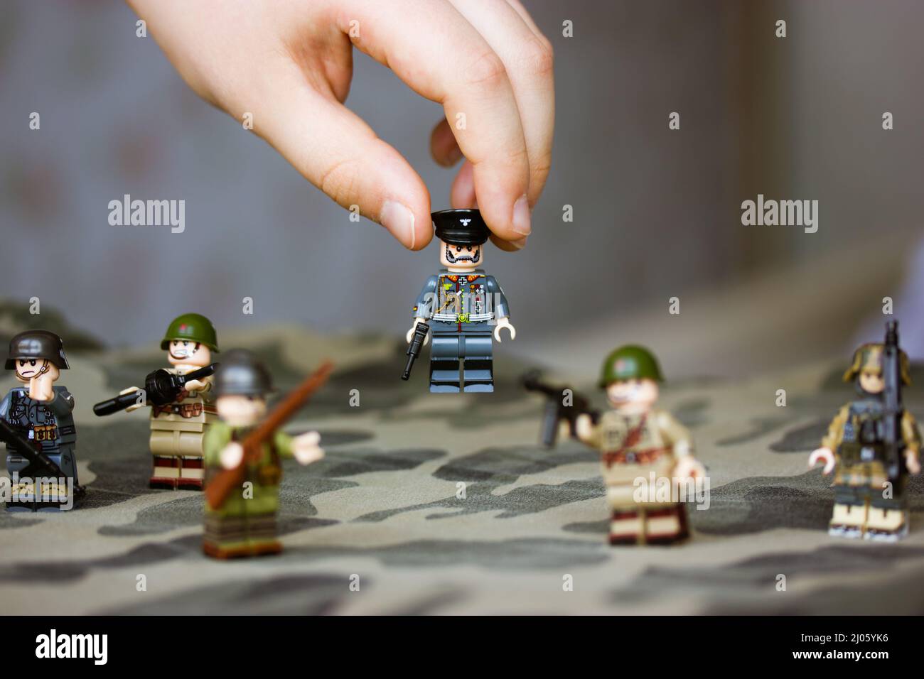 Kyiv, Ukraine. March 9, 2022. Toy officer in hand, LEGO soldiers of ...