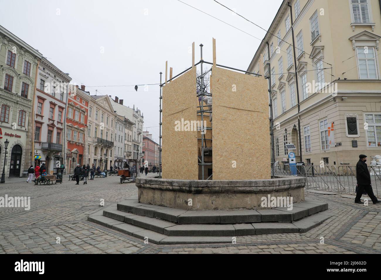 A statue, wrapped in plastic and surrounded by scaffolding to protect ...