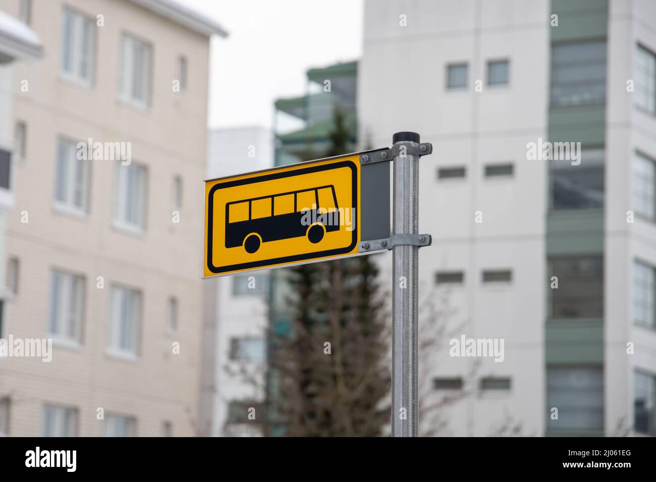 yellow sign 'bus stop' on a city background Stock Photo - Alamy