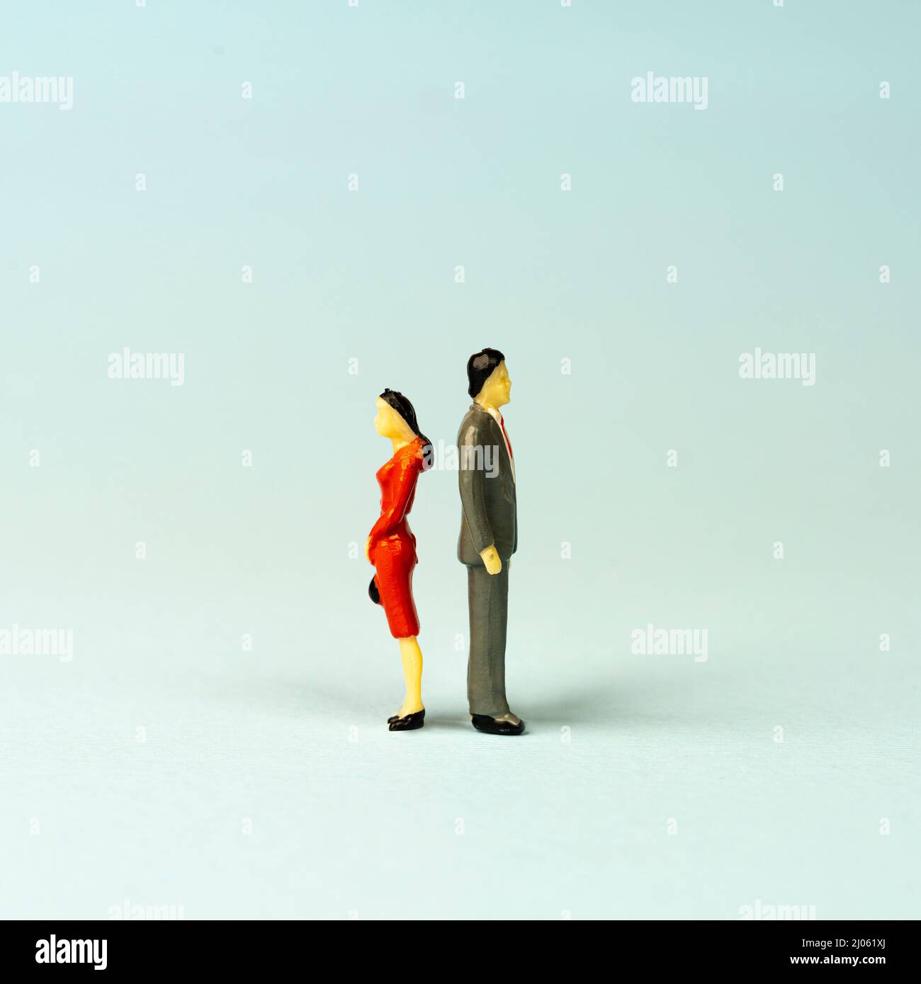 a couple of figurines turned from the back in a conflict situation ...