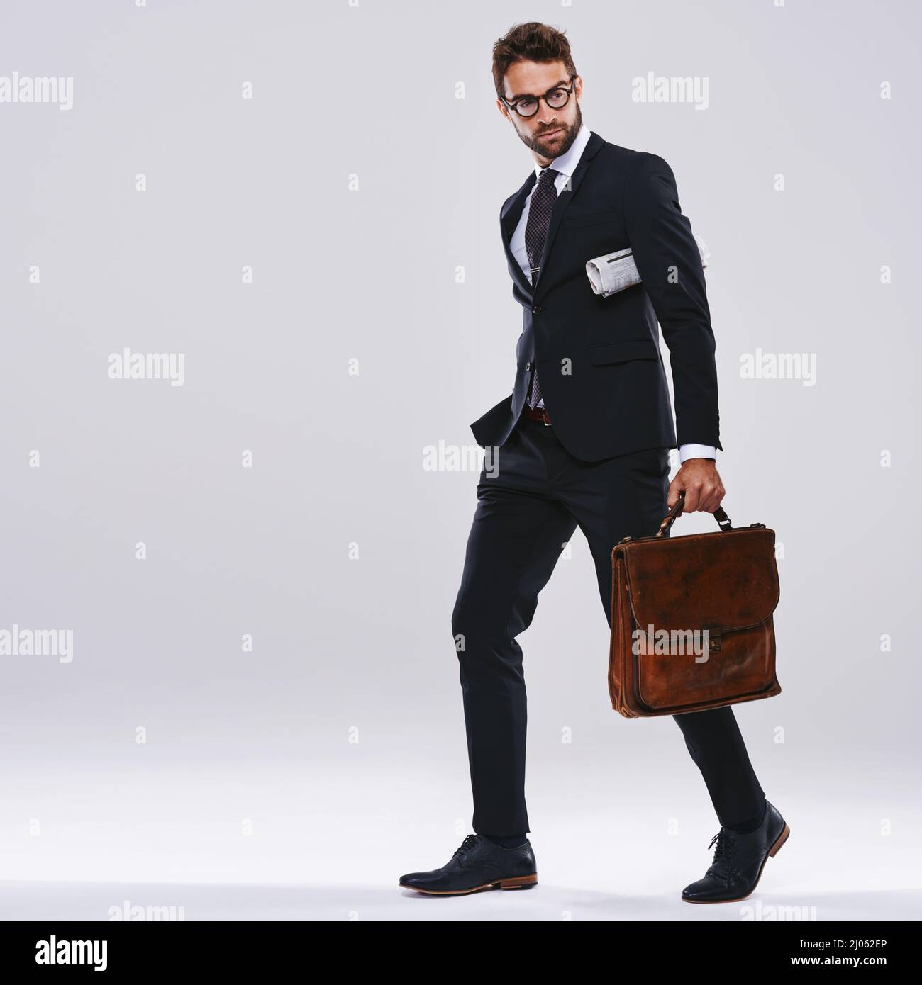 Headed to work. Studio shot of a handsome and well-dressed young man ...