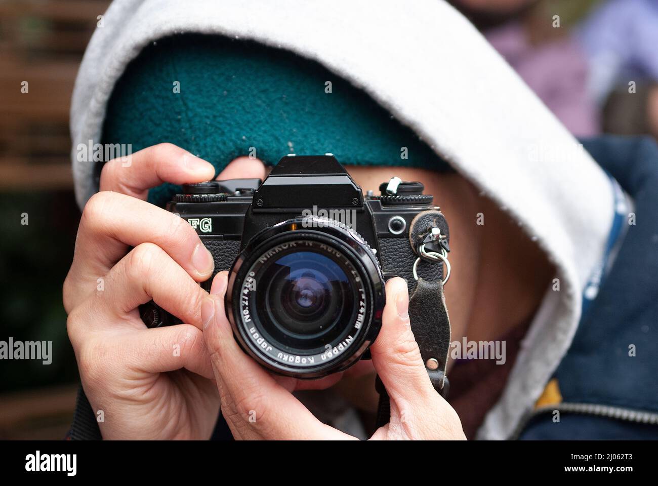 Man looking through Camera Lens Stock Photo - Alamy