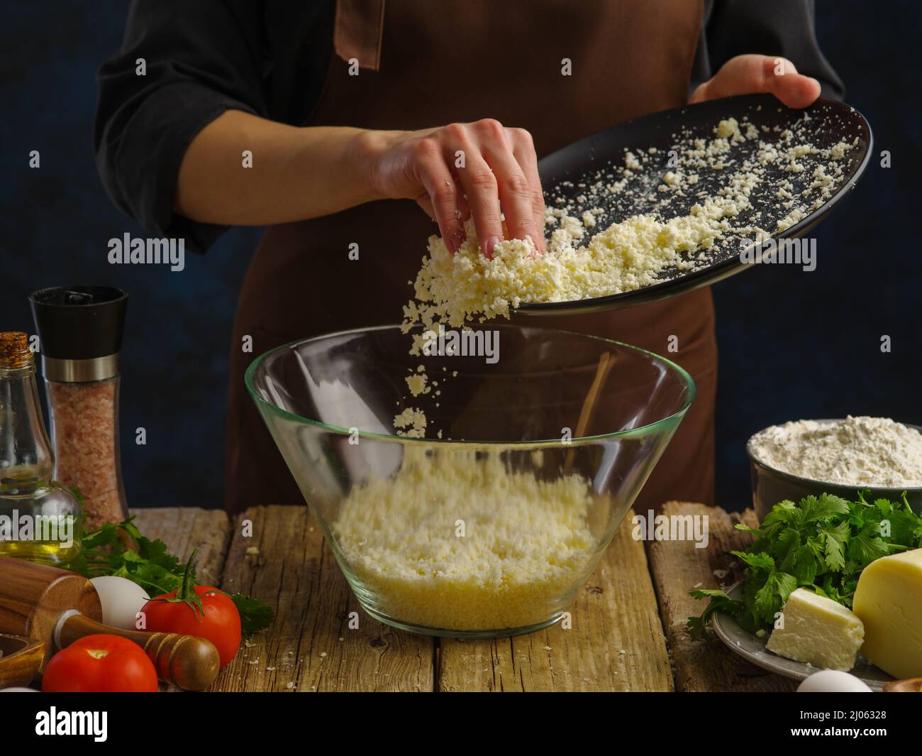 Cooking dishes with the addition of grated cheese. A professional chef ...