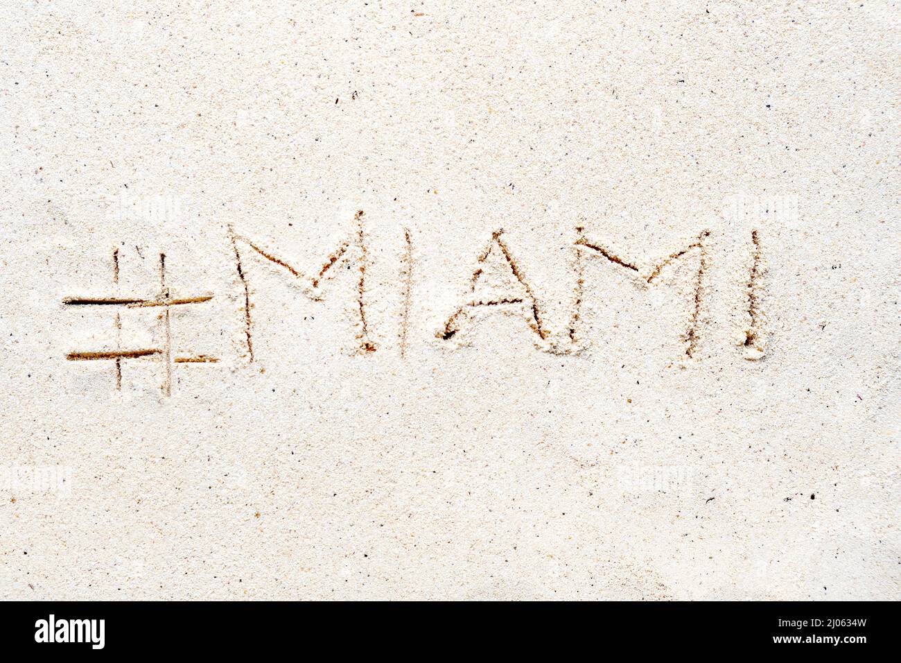 Handwriting words "Miami" on sand of beach Stock Photo - Alamy