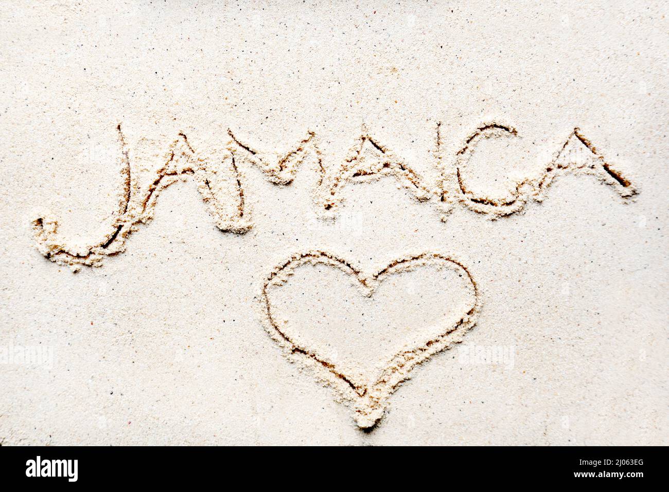 Handwriting words "Jamaica" on sand of beach Stock Photo - Alamy