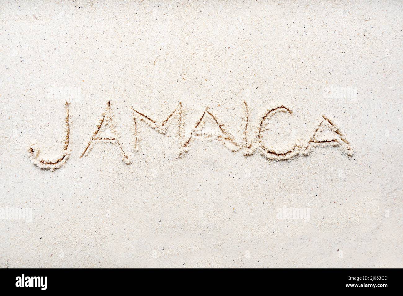 Handwriting words "Jamaica" on sand of beach Stock Photo - Alamy