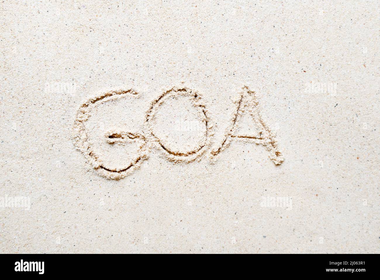 Handwriting words "Goa" on sand of beach Stock Photo - Alamy