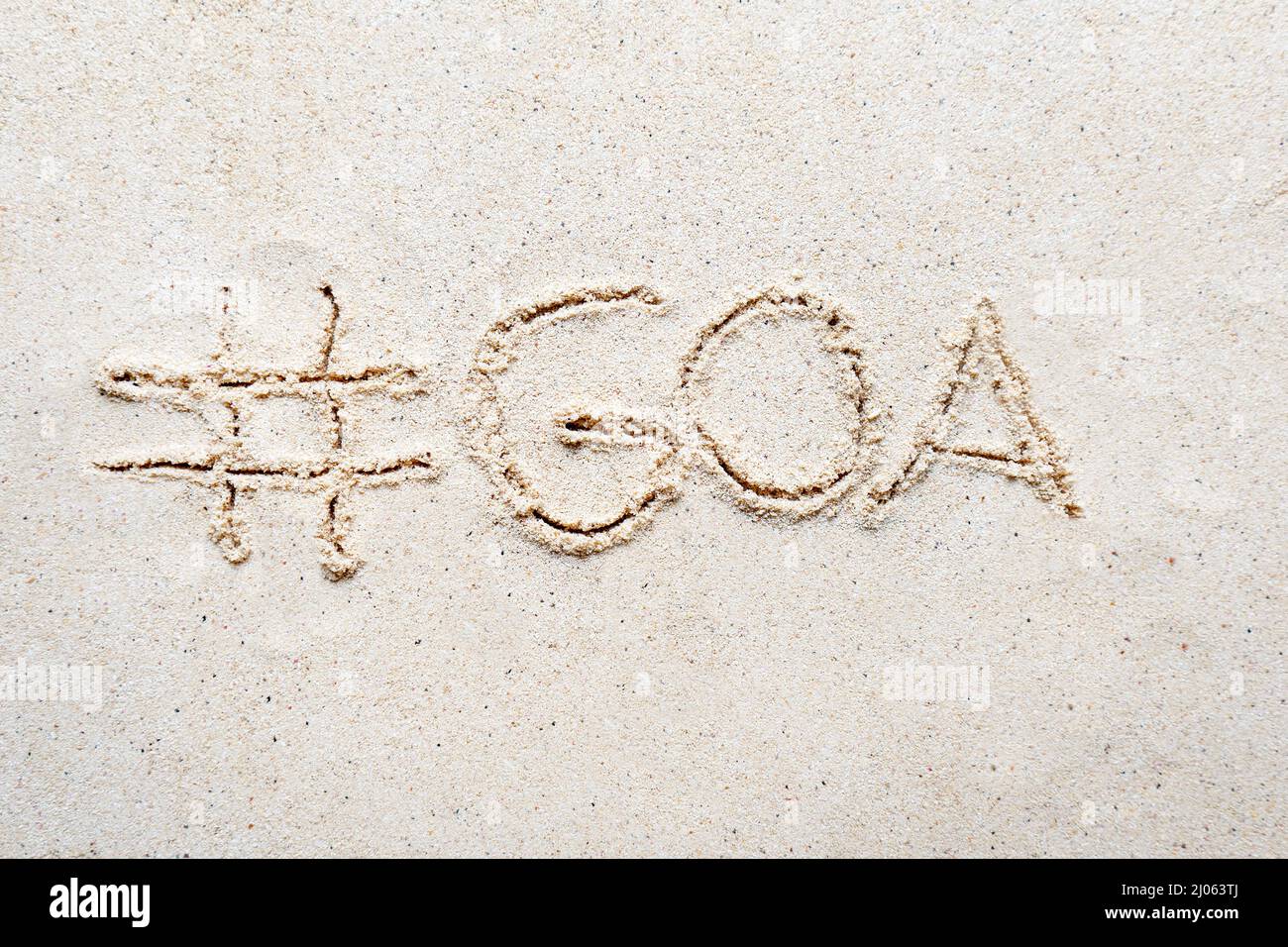Handwriting words "Goa" on sand of beach Stock Photo - Alamy