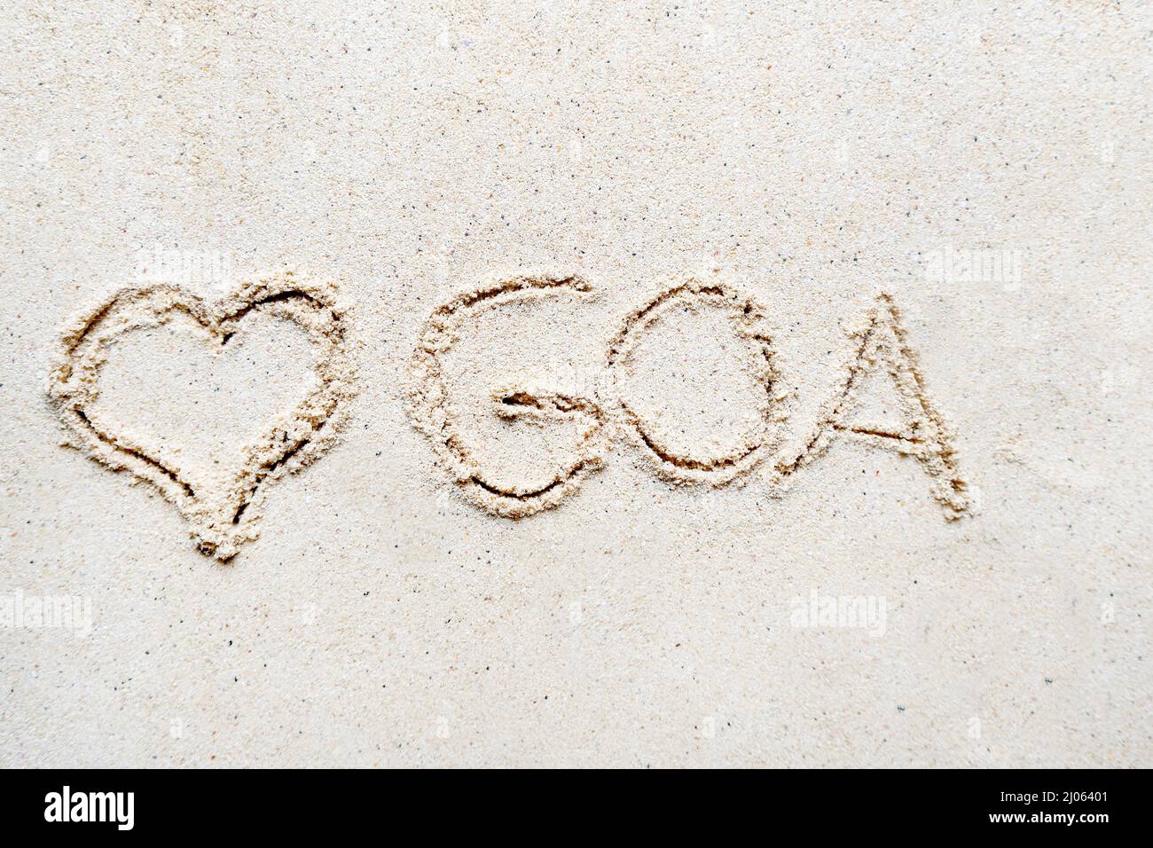 Handwriting words "Goa" on sand of beach Stock Photo - Alamy