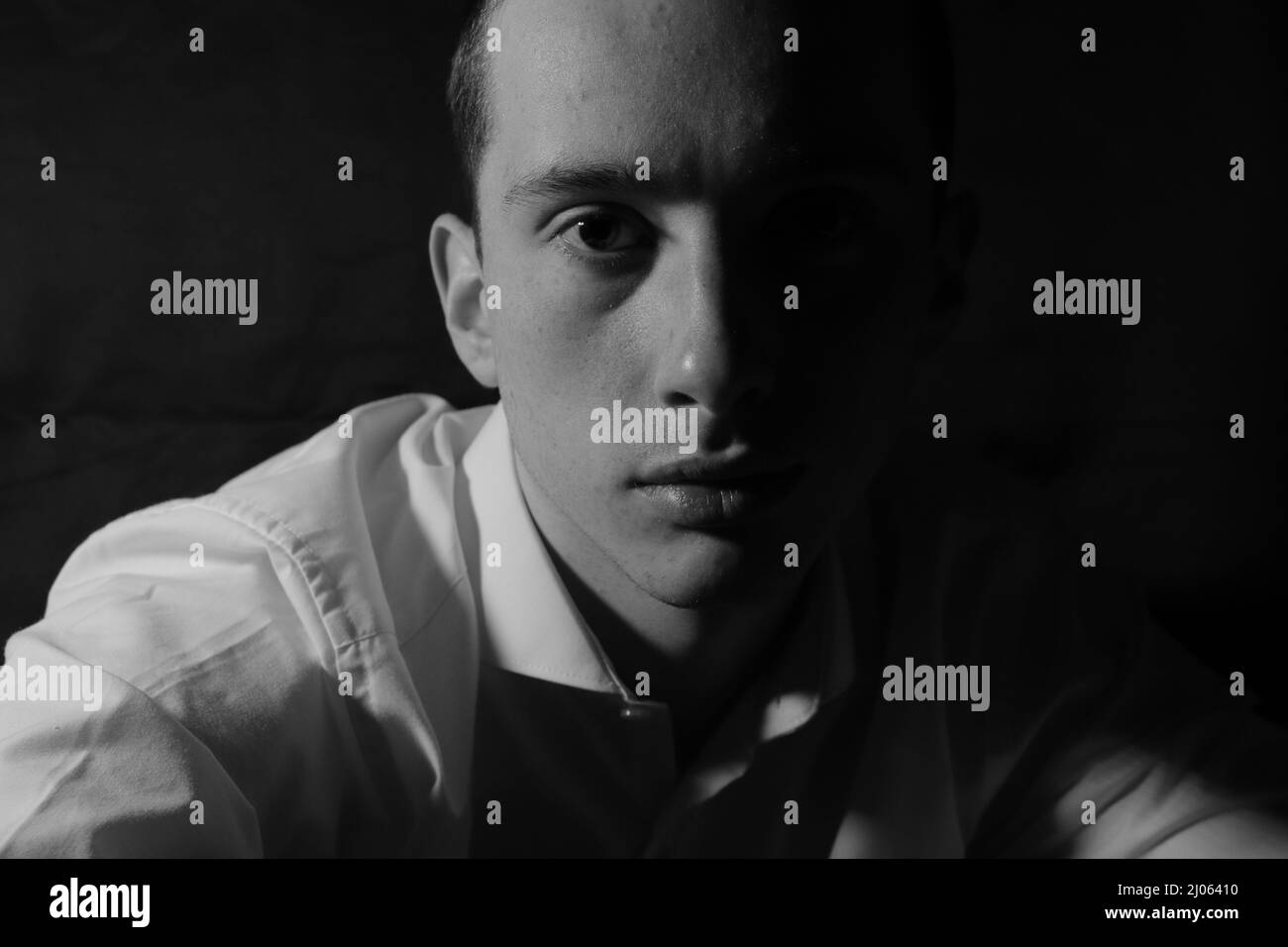 Young adult male short dark Black and White Stock Photos & Images - Alamy