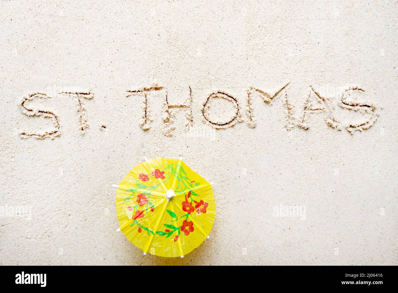 Handwriting words "St. Thomas" on sand of beach Stock Photo - Alamy