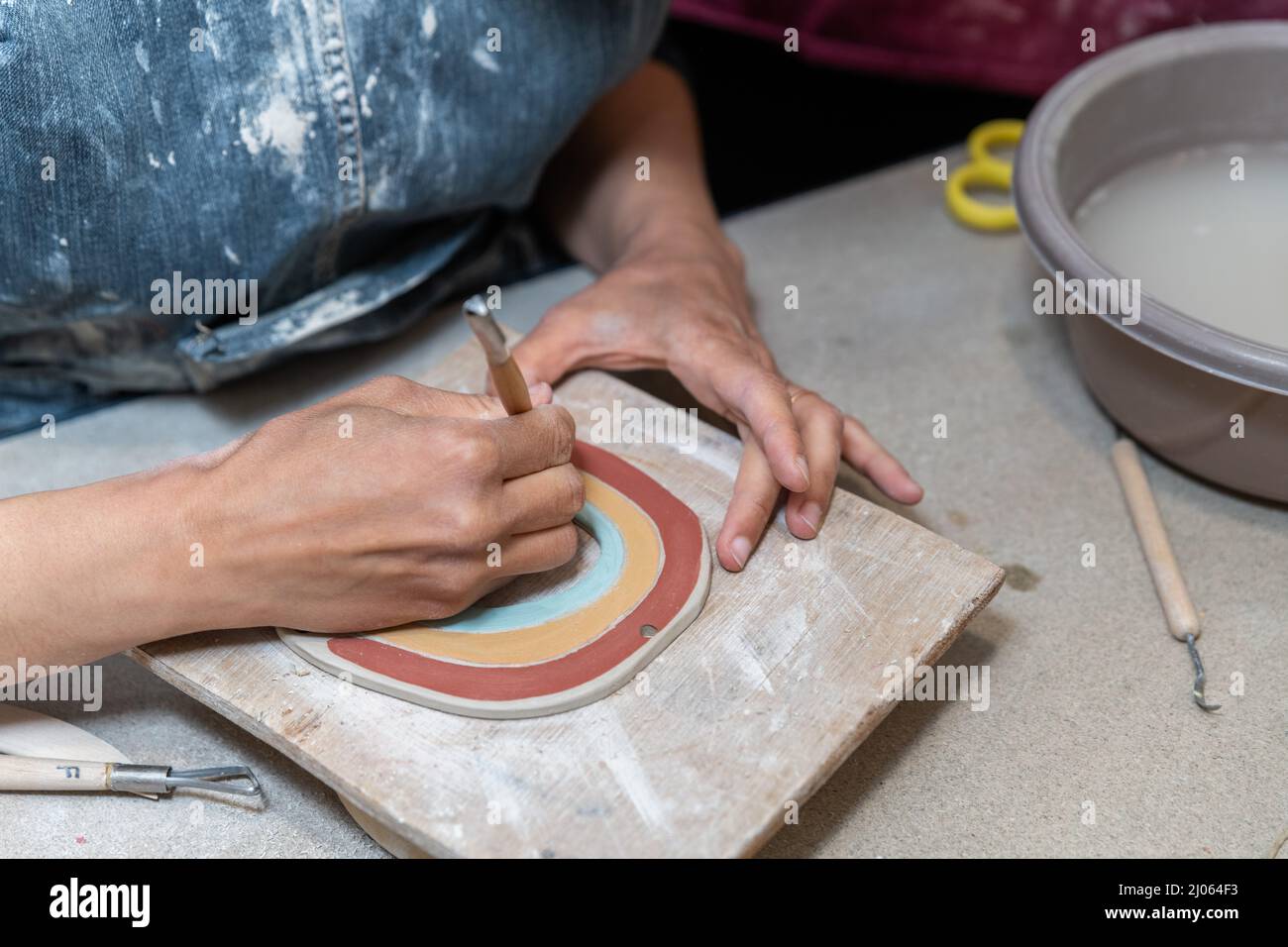 women's hands painting a pottery object Stock Photo - Alamy