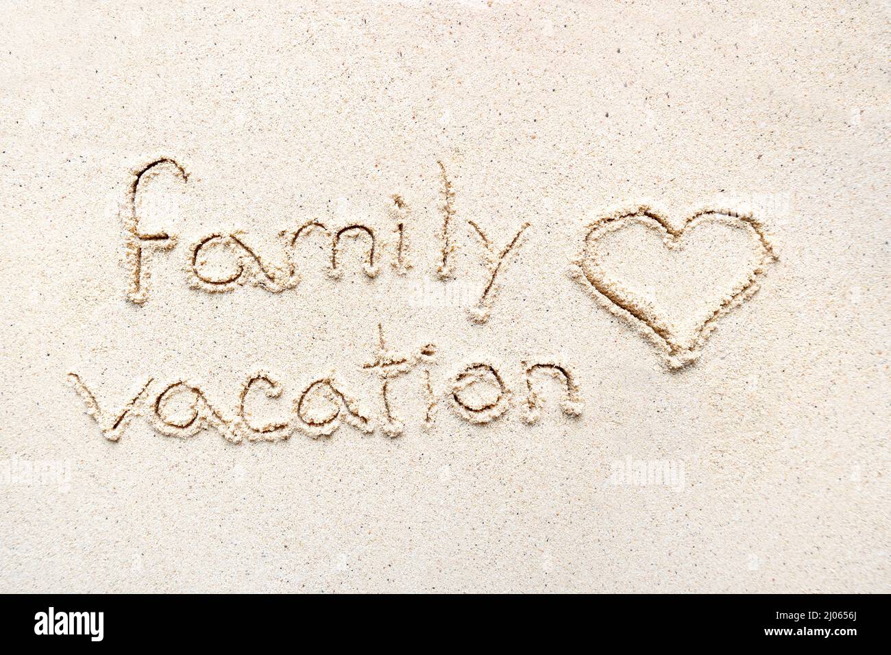 Handwriting words "Family Vacation" on sand of beach Stock Photo - Alamy