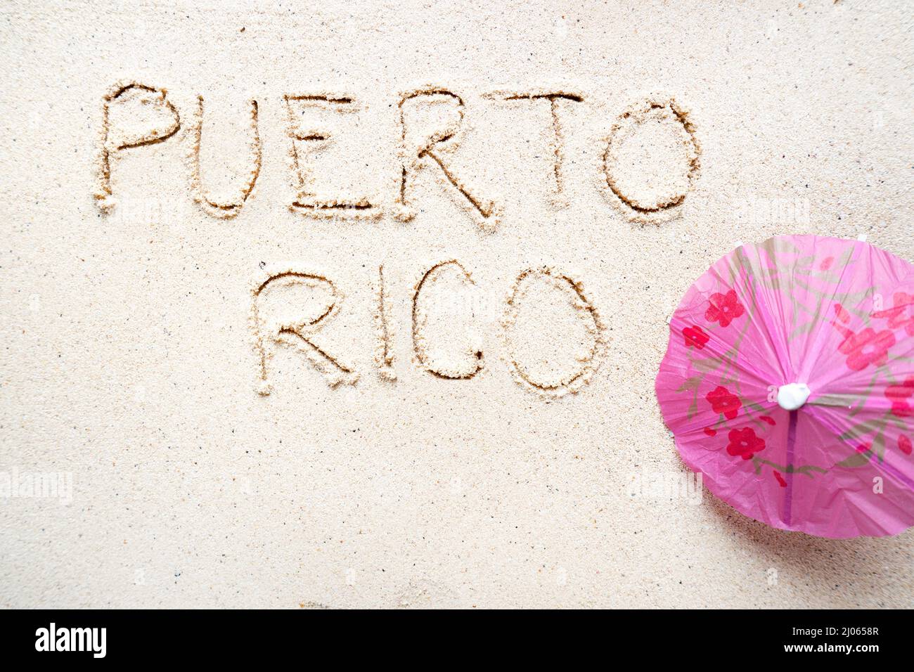 Handwriting words "Puerto Rico" on sand of beach Stock Photo - Alamy