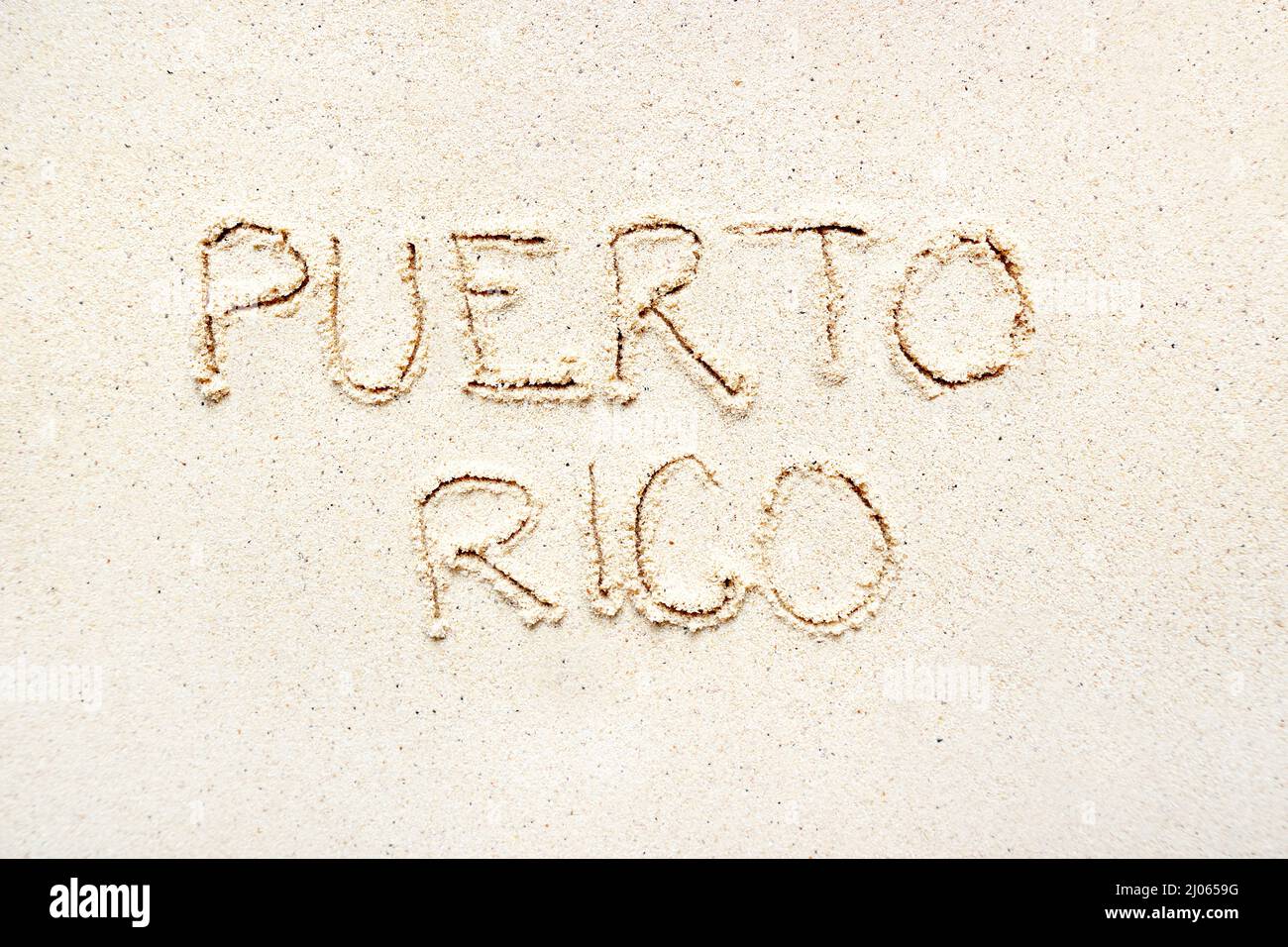 Handwriting words "Puerto Rico" on sand of beach Stock Photo - Alamy