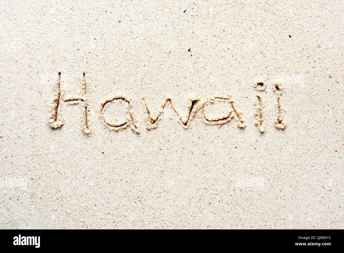 Handwriting words "Hawaii" on sand of beach Stock Photo - Alamy