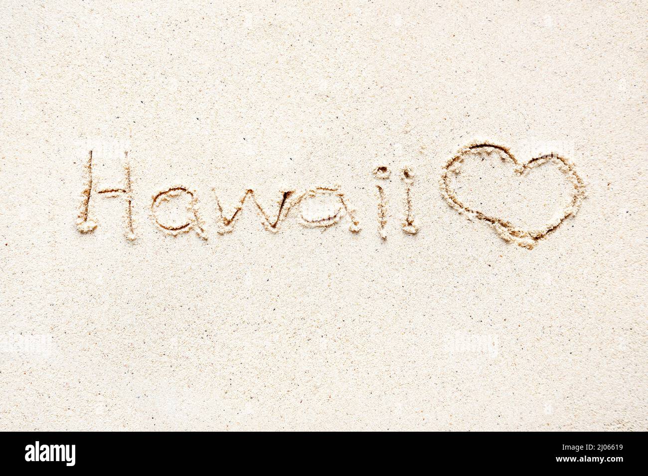 Handwriting words "Hawaii" on sand of beach Stock Photo - Alamy