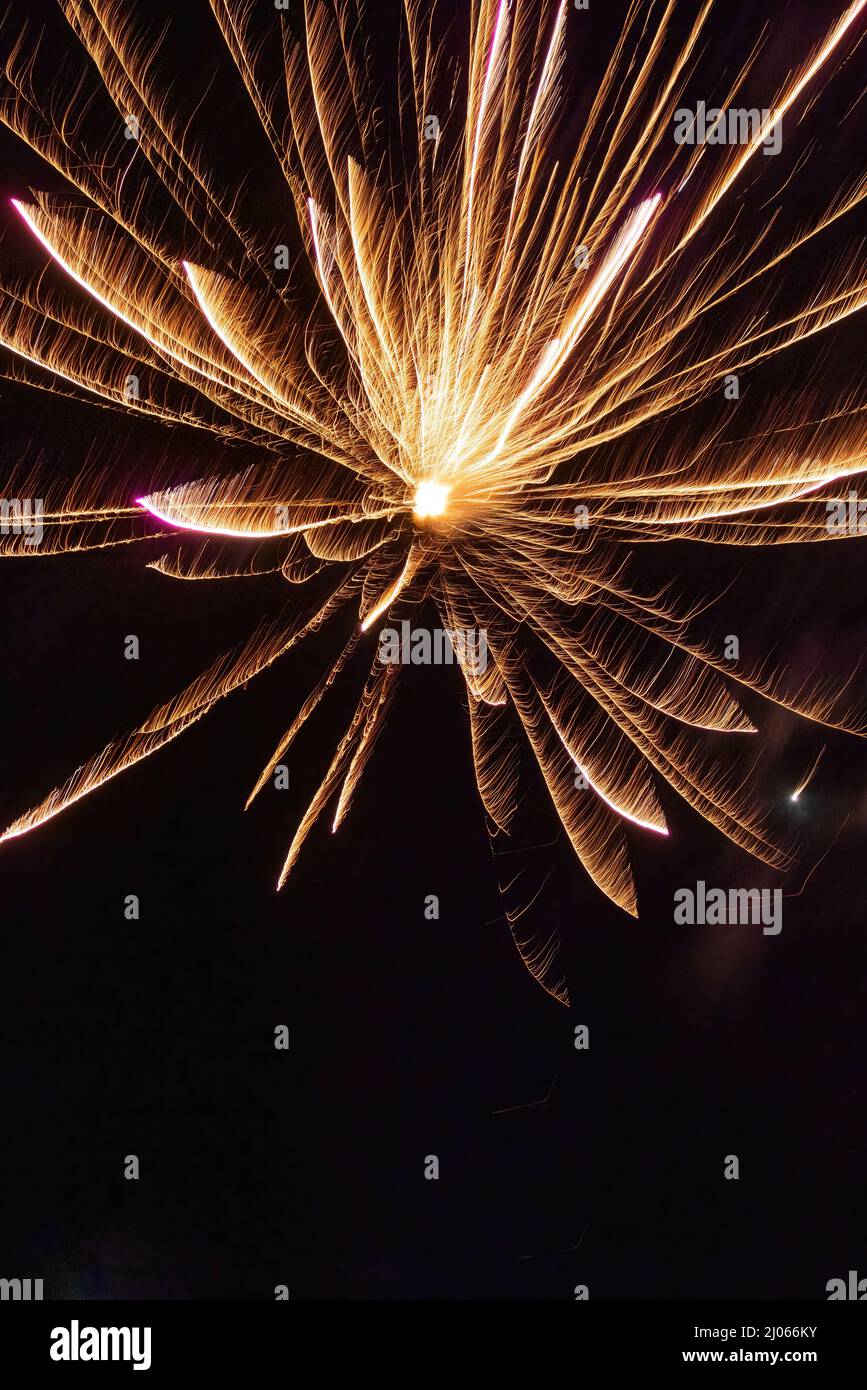 golden sparks trailing through sky from firework Stock Photo - Alamy
