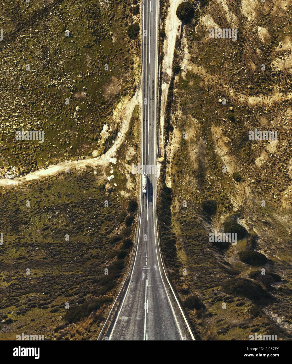 Aerial view of an up curving road with meadow Stock Photo - Alamy