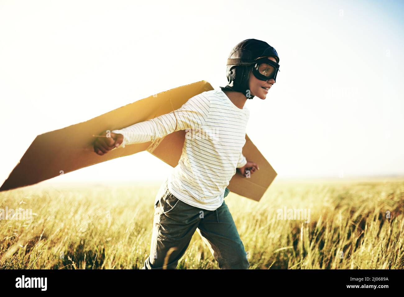Ready for lift off. Shot of a young boy pretending to fly with a pair ...