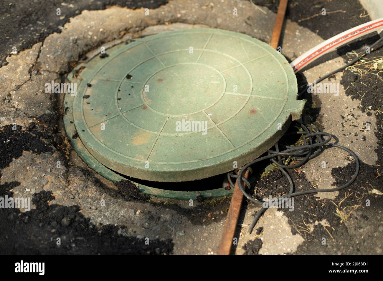 Sewer manhole made of plastic.The hatch is open. Access to hidden ...