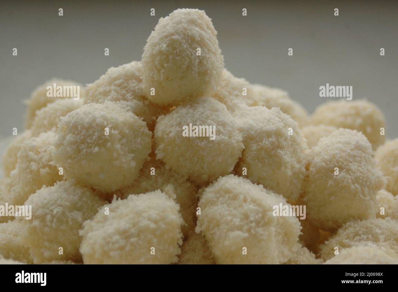 Homemade Raw Coconut Candies Stacked Stock Photo - Alamy