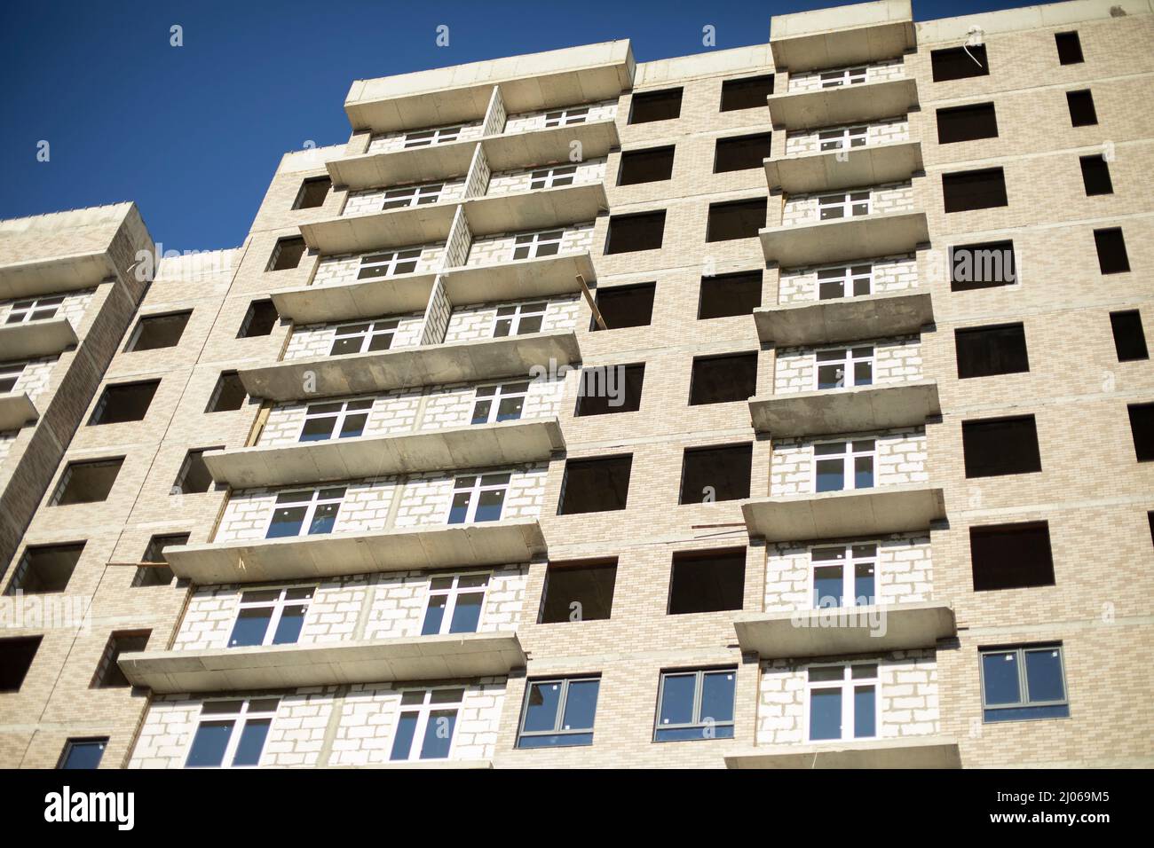A house under construction. Windows in the building. Construction of an ...