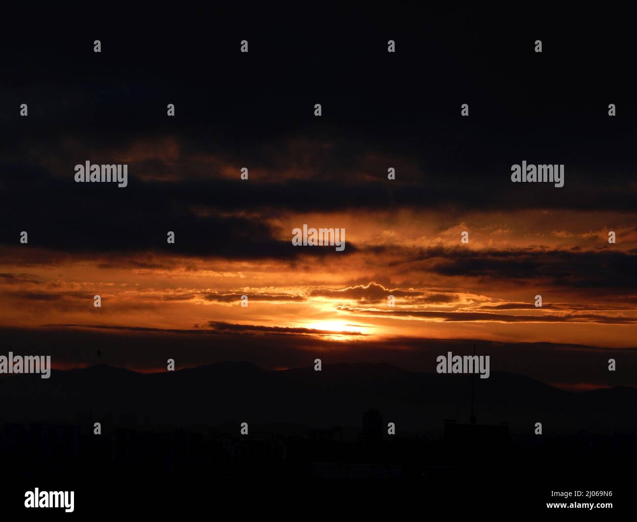 Flaming Sunset Under Cloudy Sky Stock Photo - Alamy