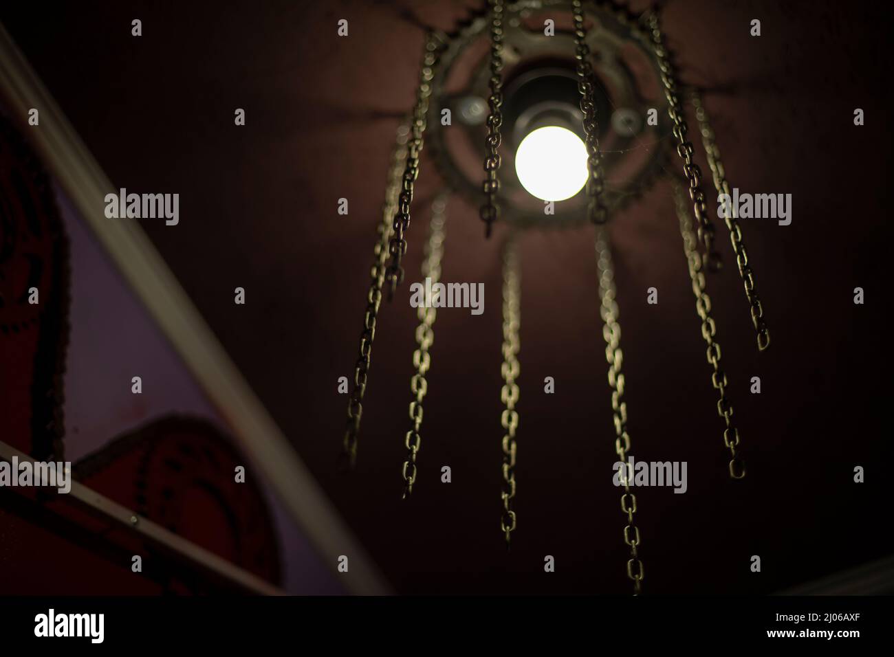 Lamp in bar. Interior decoration. Chandelier with chains. Unique light ...