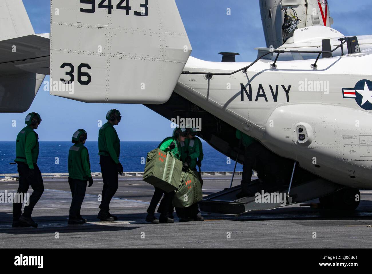 PHILIPPINE SEA (March 16, 2022) Sailors unload cargo from a CMV-22B ...