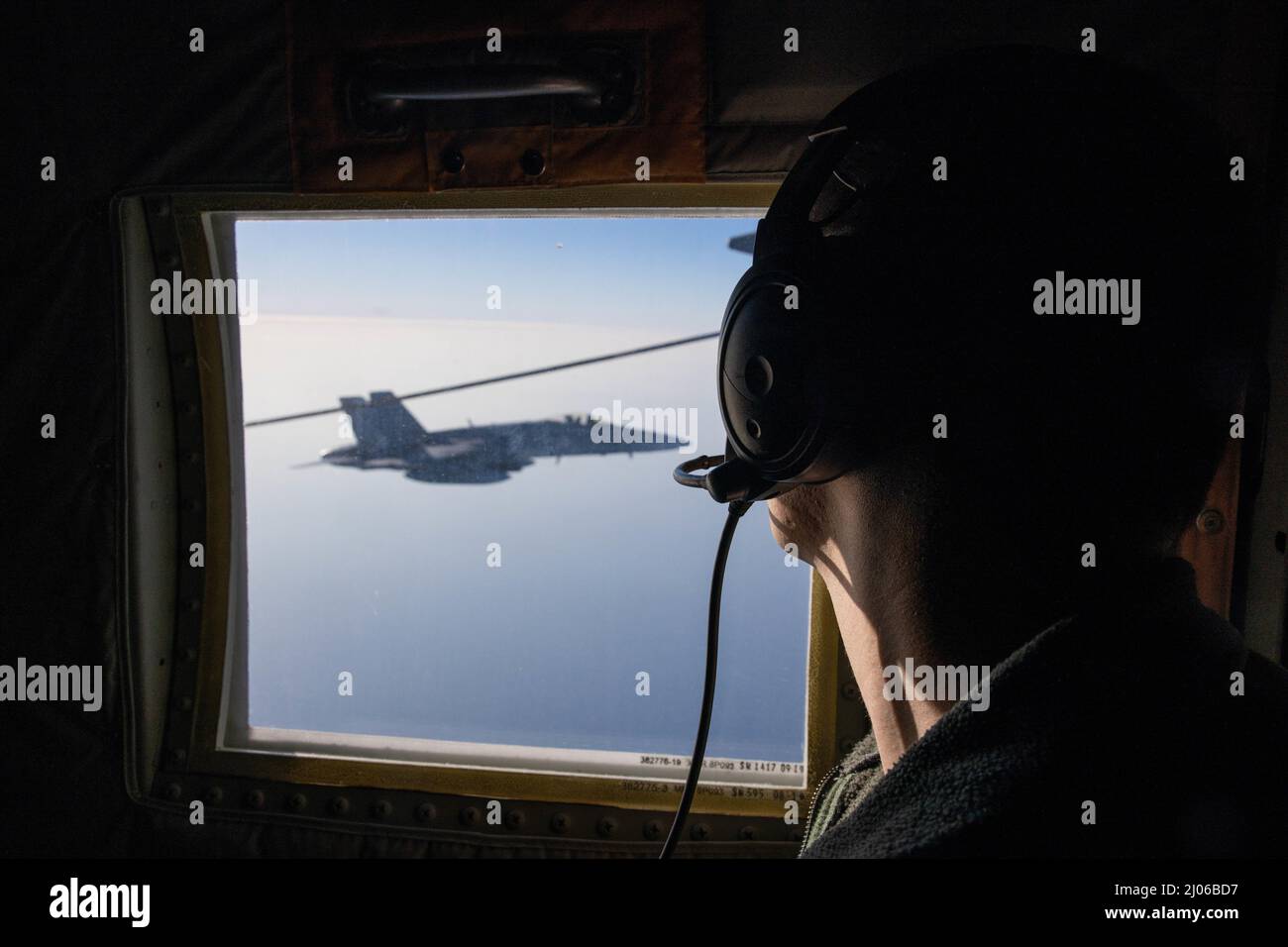 U.S. Marine Corps Cpl. Brandon Slone watches as an F/A-18C Hornet ...