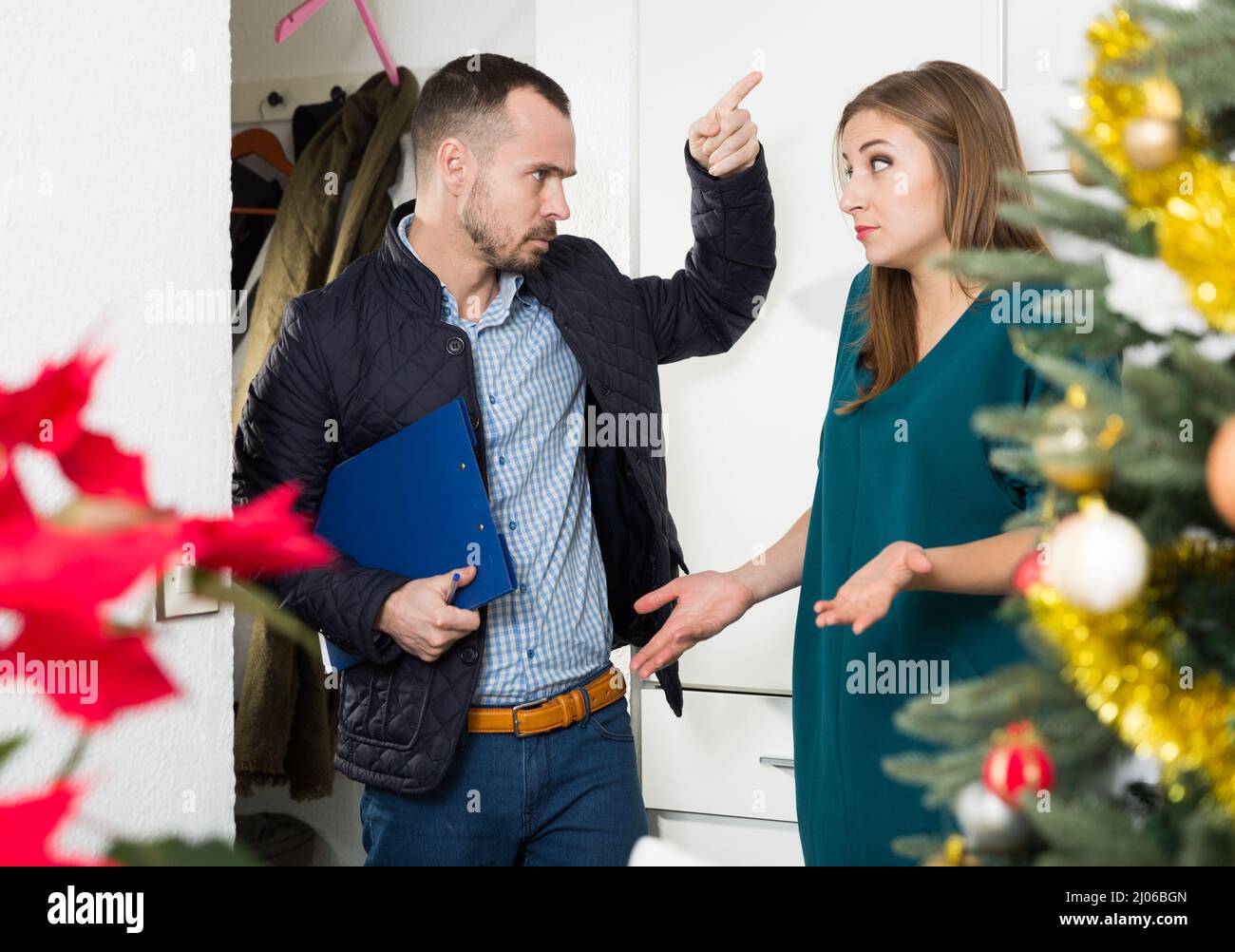 Male collection agency manager visiting young woman on Christmas ...