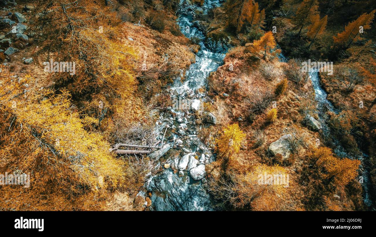 Aerial view of the fall color along a small shallow creeks flowing in ...