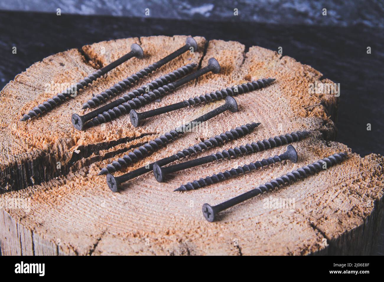 Fasteners for wood. Self-tapping screws on a wooden table. Nails and ...
