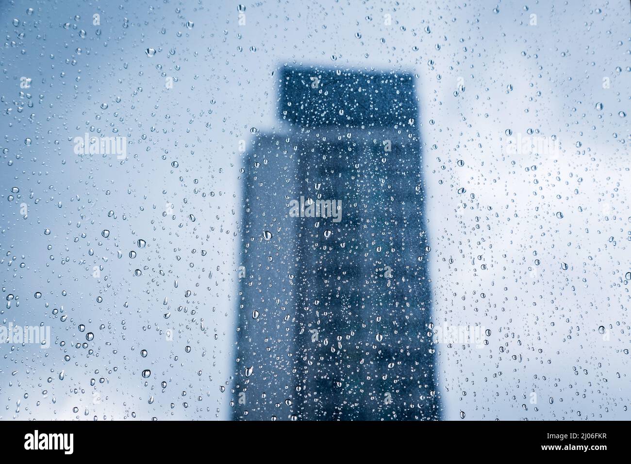 Abstract image of Rain drops on the dirty glass windows with modern ...