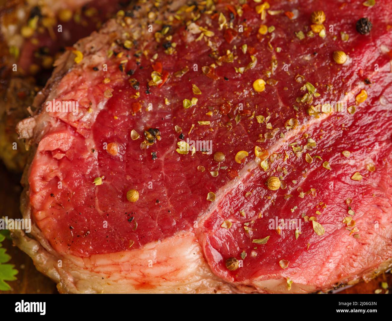 Macro shot. Juicy steak sprinkled with salt and spices. The concept is ...