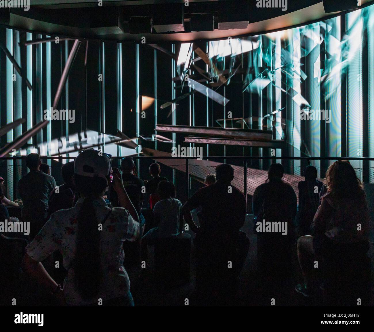 People watching video reel projected on the wall Stock Photo - Alamy