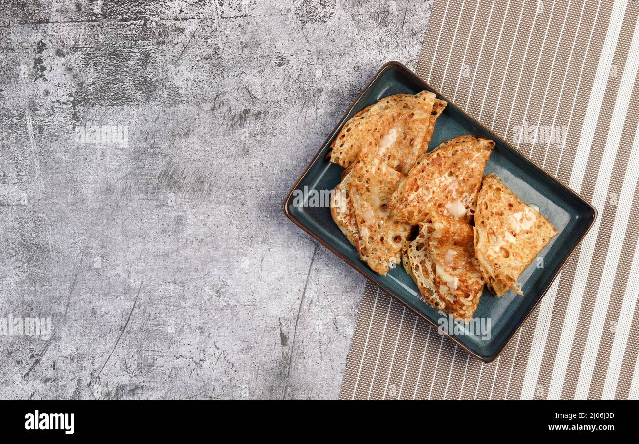 Traditional russian yeast thin pancakes (crepes) on a rectangular plate ...