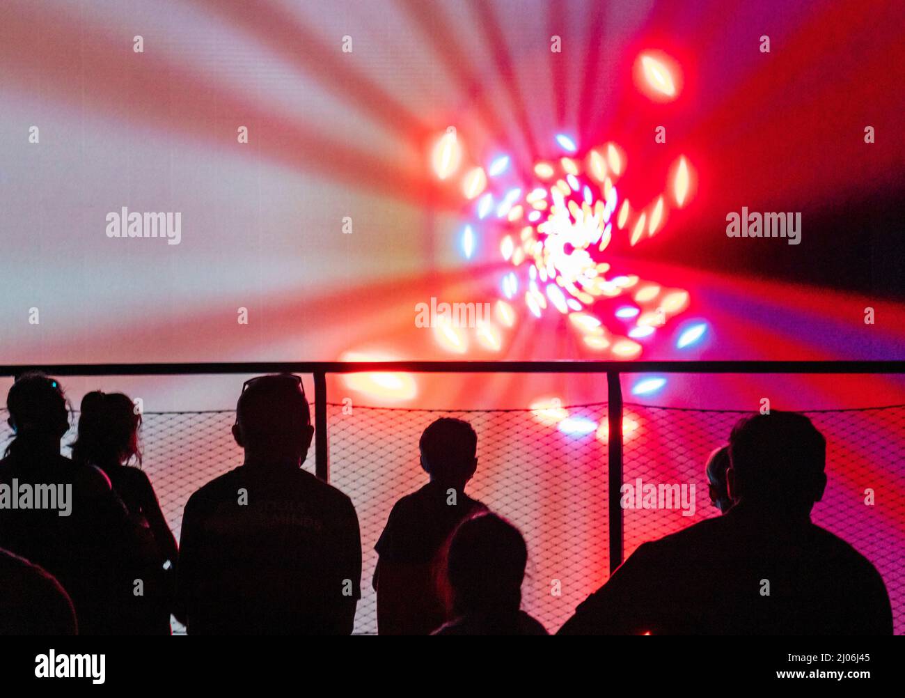 People watching video reel projected on the wall Stock Photo - Alamy