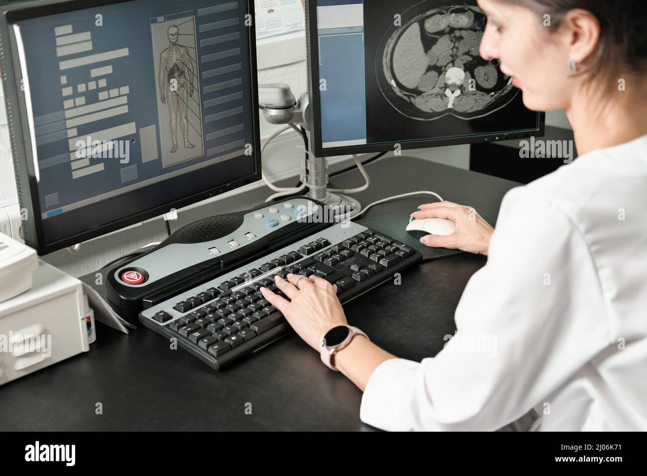 middle east woman doctor looking at monitor with computer tomography ...