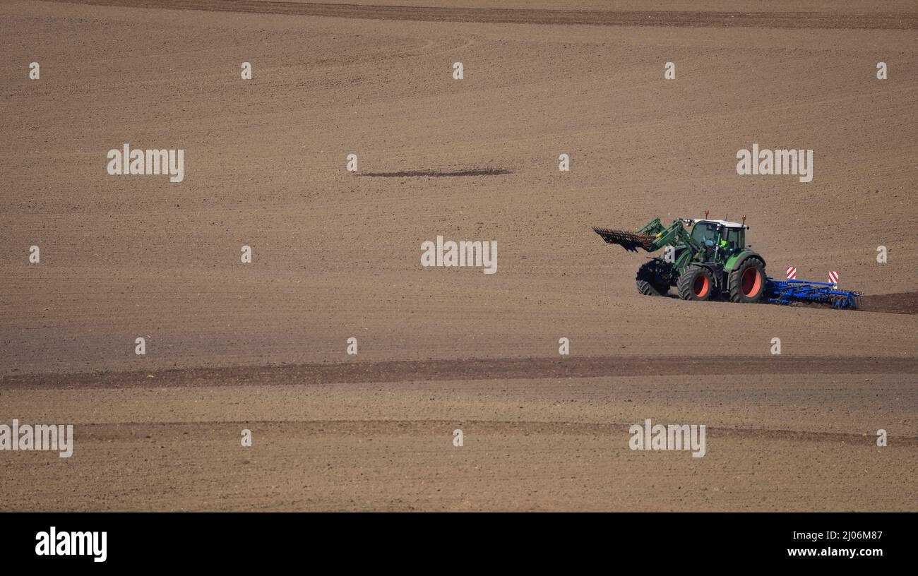 Panker, Germany. 11th Mar, 2022. A farmer digs a field for sowing oats ...