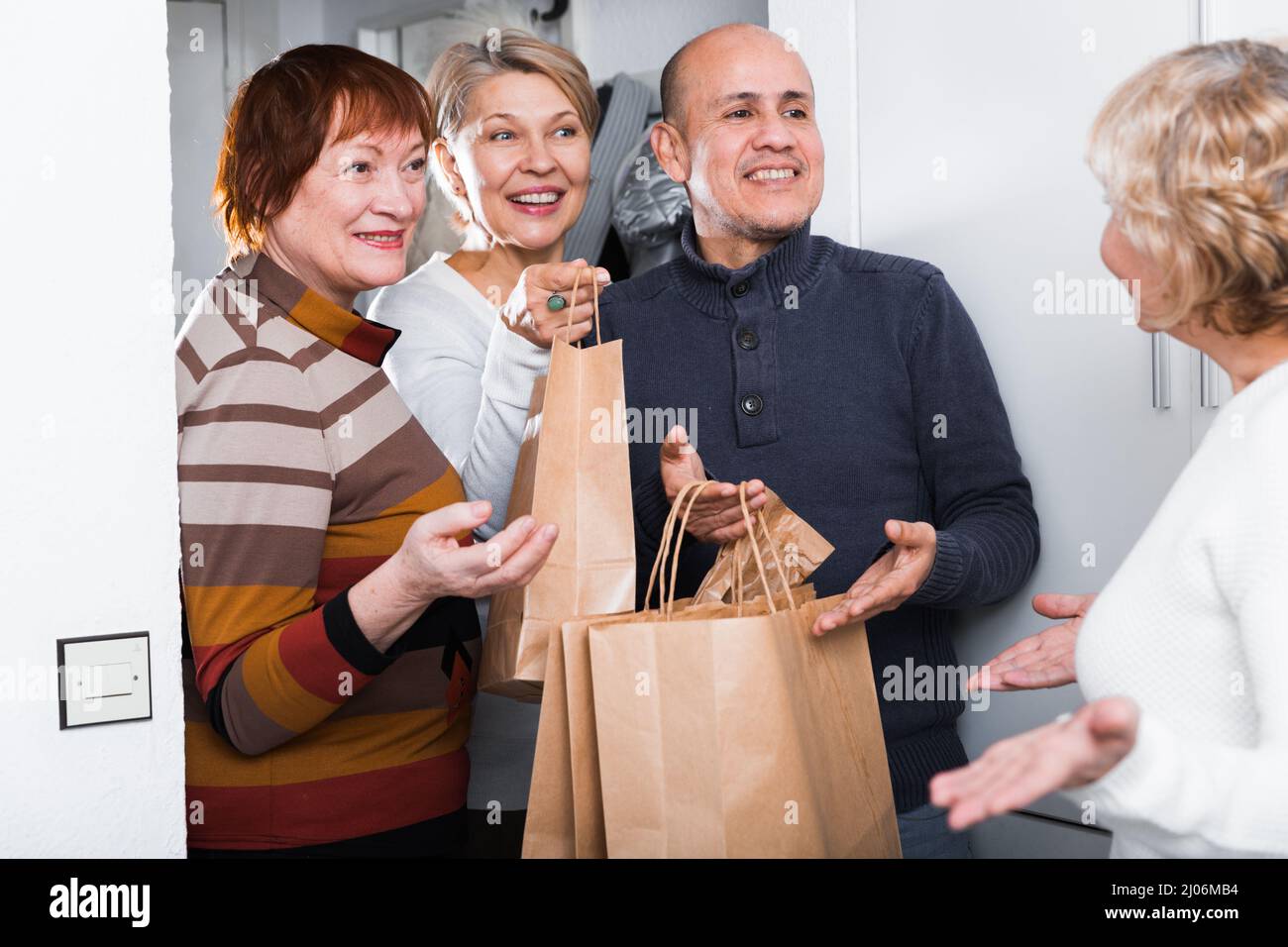 Mature friends are visiting their friend at her home Stock Photo - Alamy