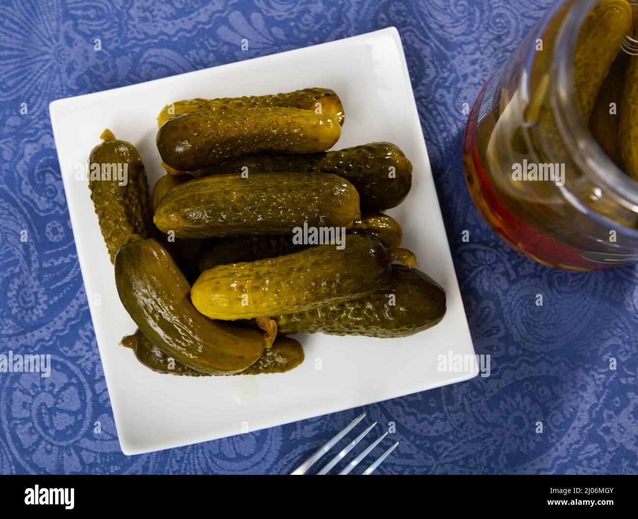 Traditional russian cuisine, preserved salted green cucumbers, served ...