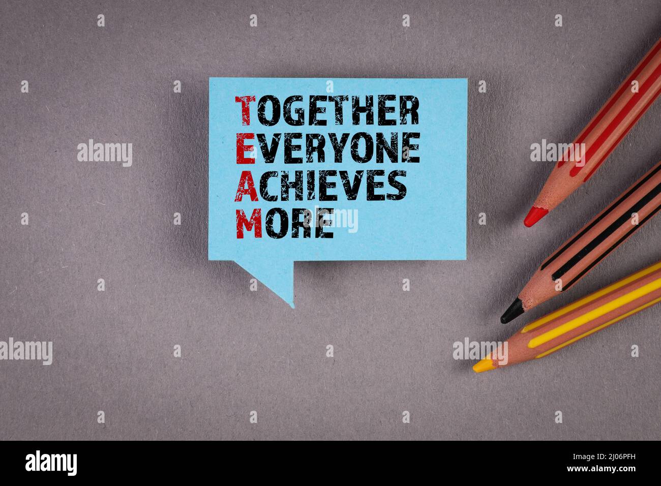 TEAM. TOGETHER EVERYONE ACHIEVES MORE. Speech bubble on a gray ...