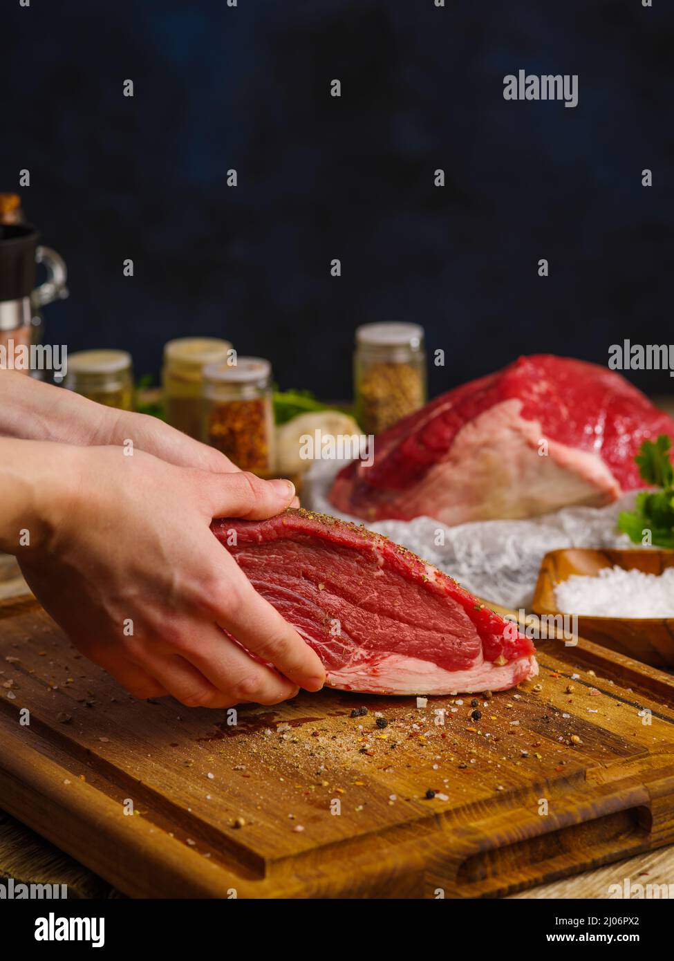 The hands of a professional chef hold a piece of fresh meat - beef ...